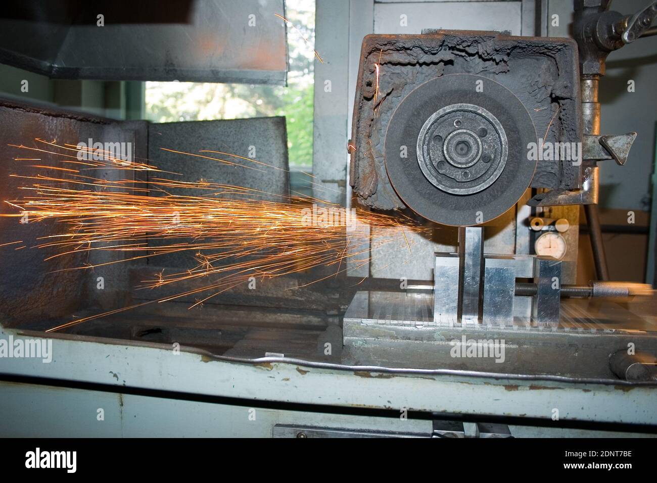 Grinding a metal part. Metal plate surface machining - grinding process ...