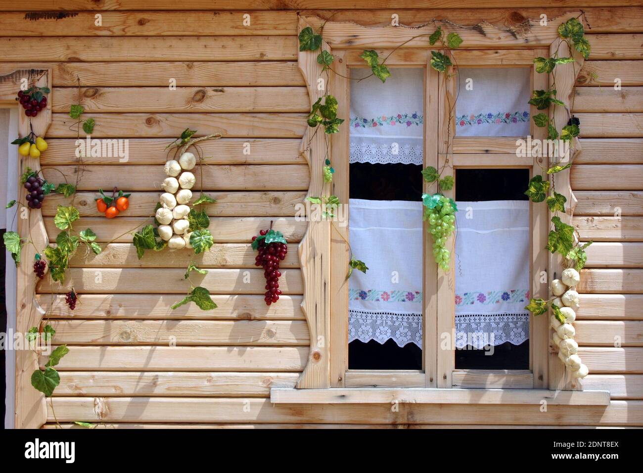 Window. Outside view. Wooden window in a wooden wall with curtains and ...