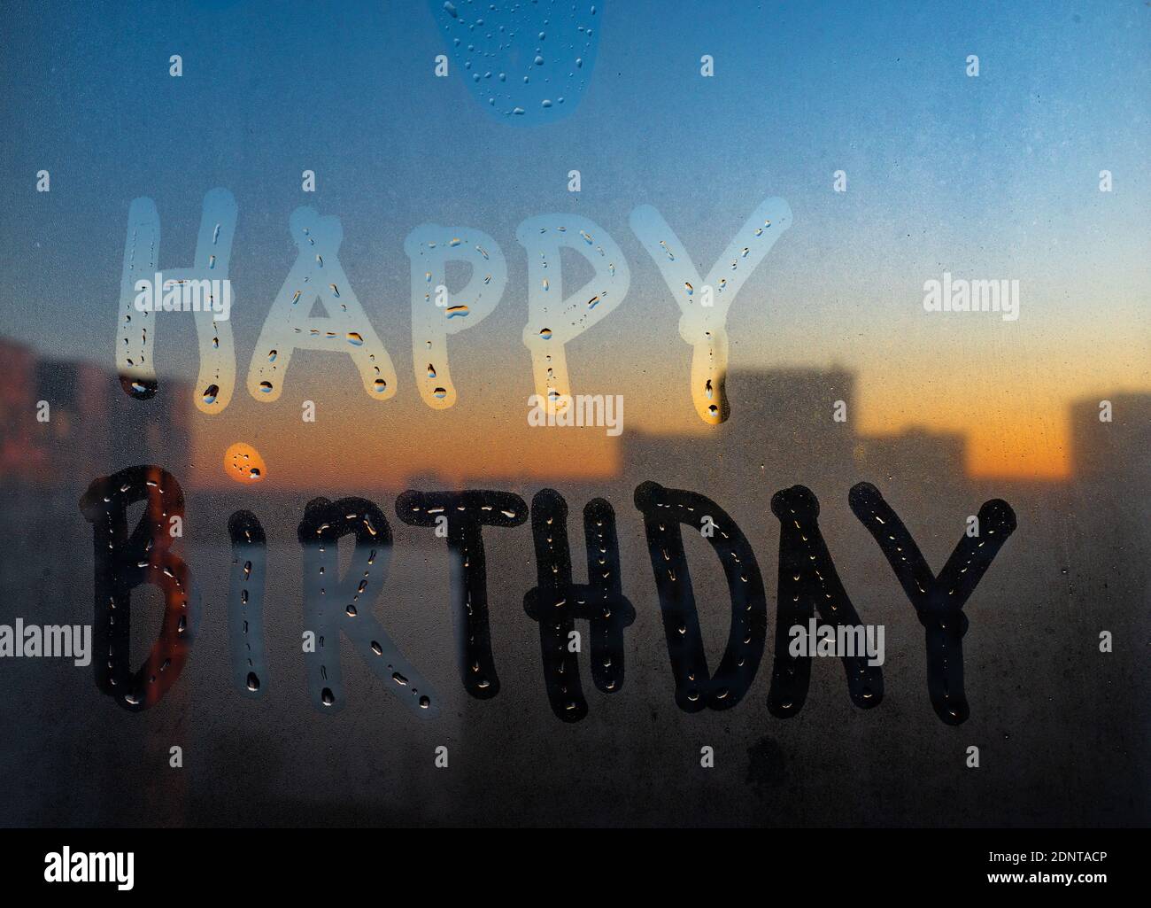 Happy birthday hand drawn on misted window glass at sunrise Stock Photo ...