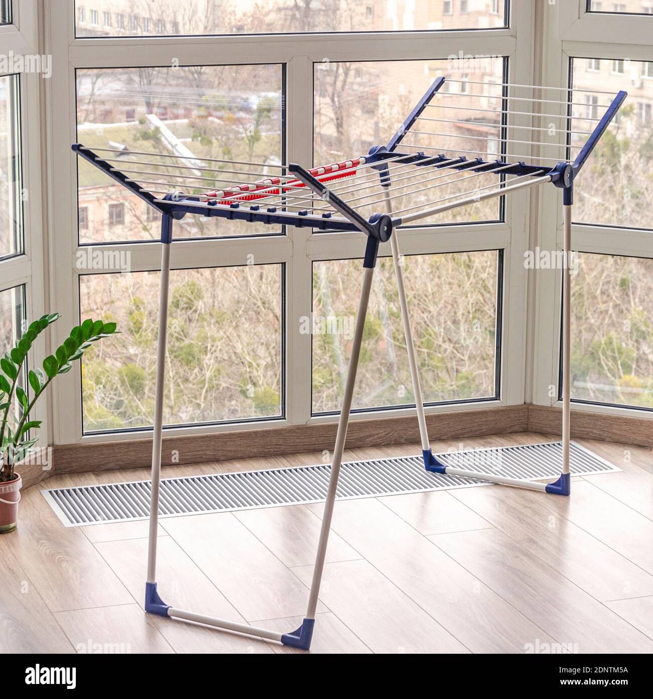 Compact folding drying for wet laundry at home Stock Photo - Alamy