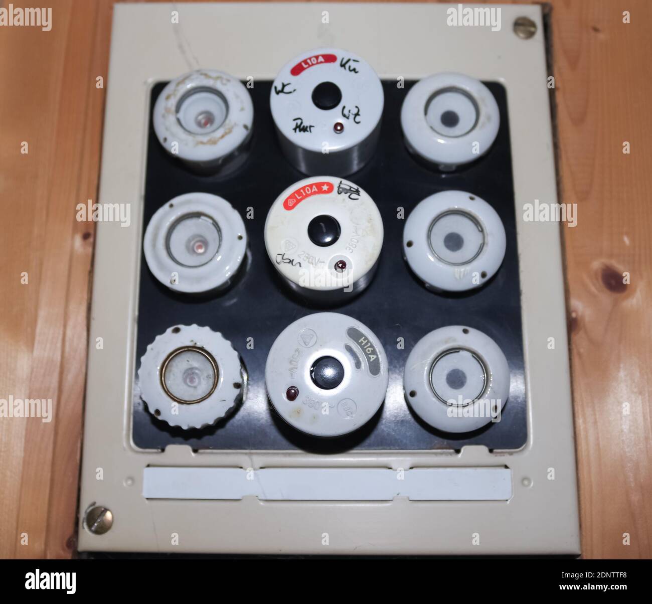 Old fuse box with ceramic fuses and some handwritings on it Stock Photo ...