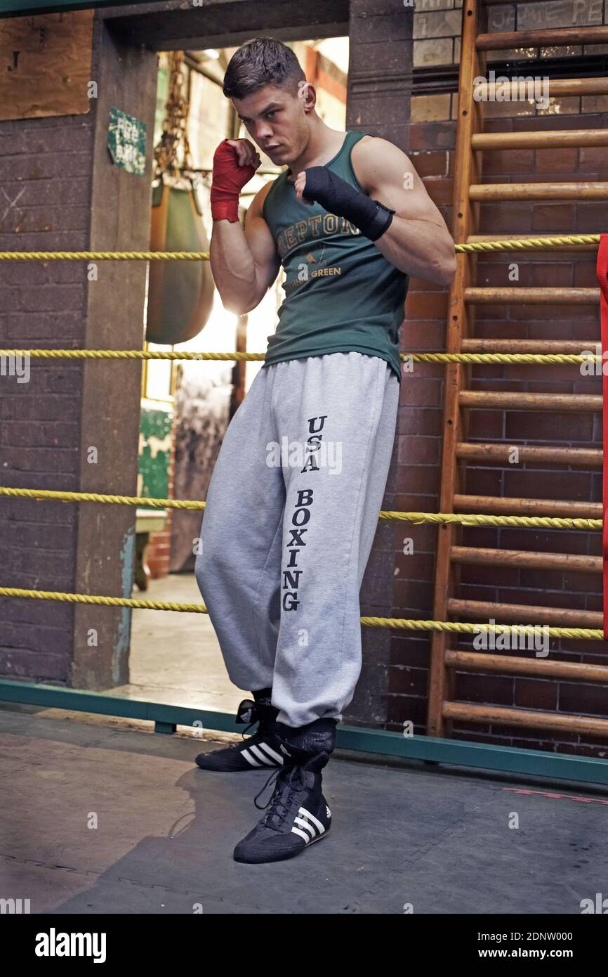 Young athletic man preparing for boxing competitions, training defense ...
