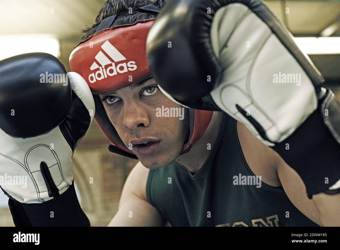 Young athletic man preparing for boxing competitions, training defense ...