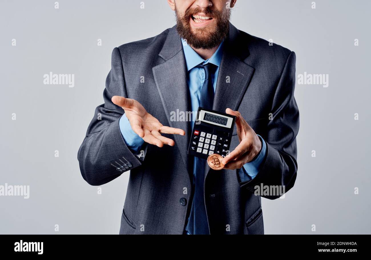 A man in a classic suit controls the hands and coins of the Bitcoin ...