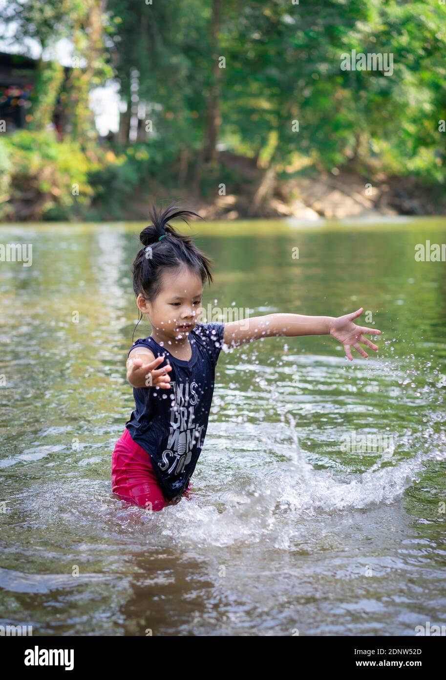 Indian girl playing in river hi-res stock photography and images - Alamy