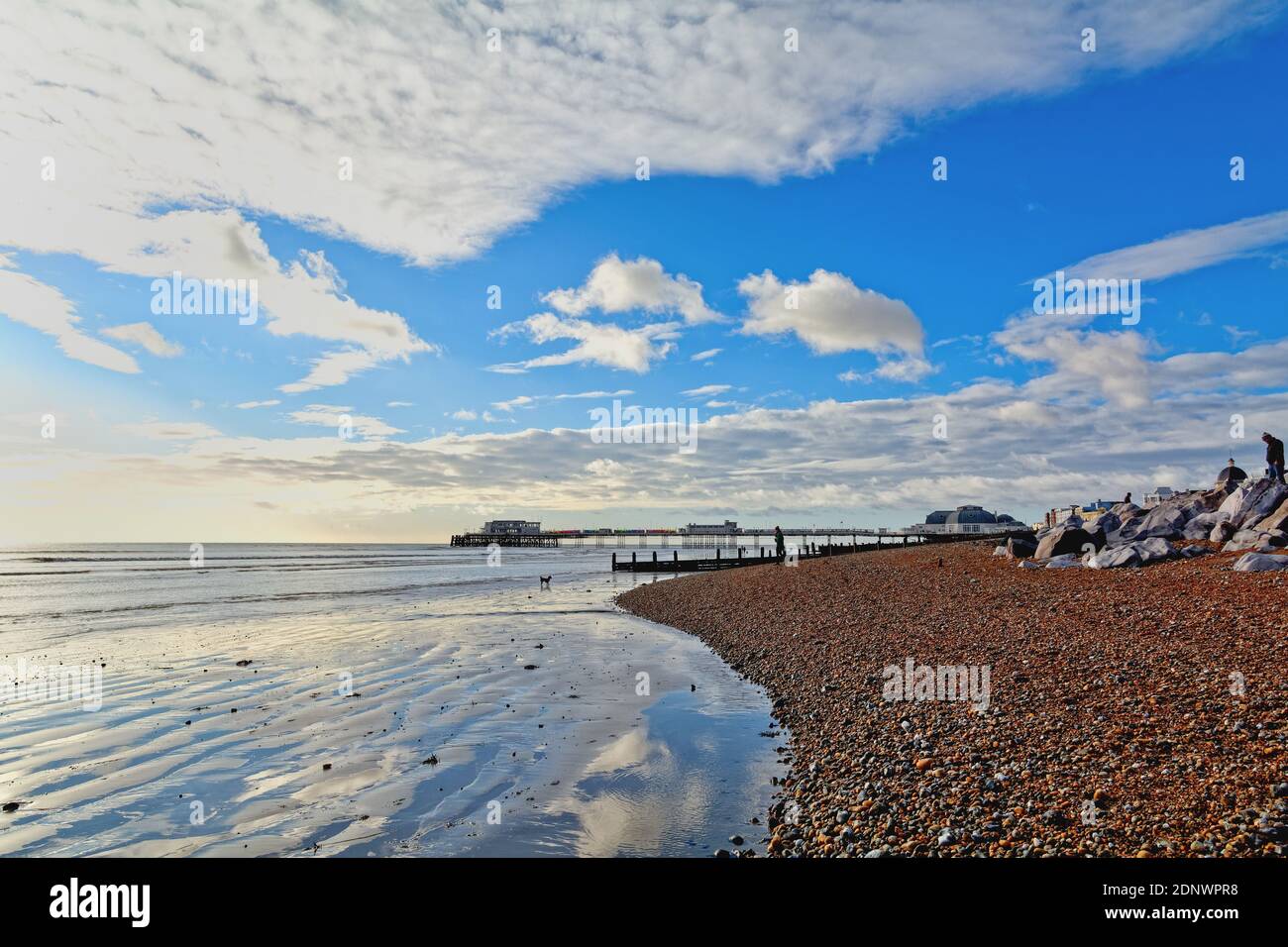 The pier at Worthing against a dramatic winter sunset and clouds west ...