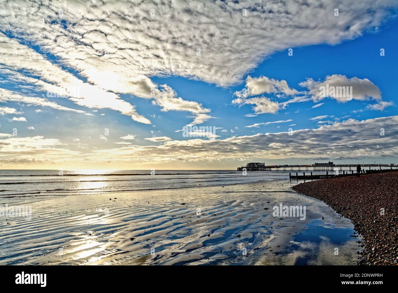 The pier at Worthing against a dramatic winter sunset and clouds west ...