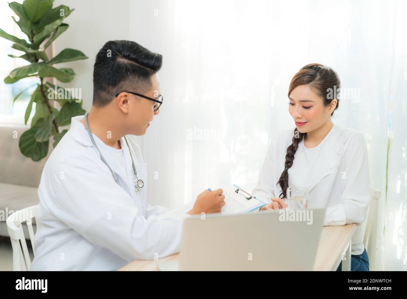 Male Obstetrician-gynecologist working with young stress woman in ...