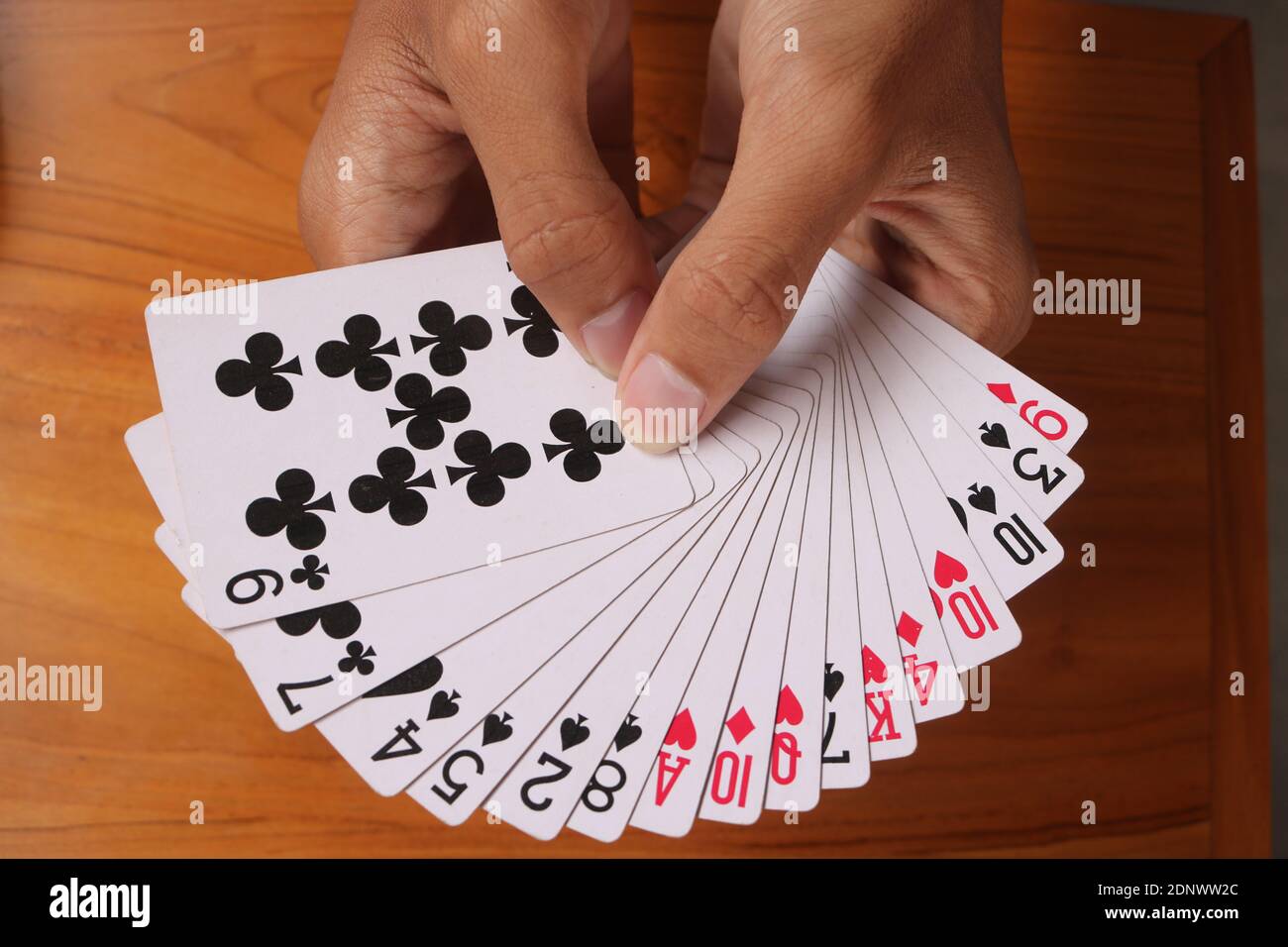 Cropped hands holding playing cards hi-res stock photography and images ...