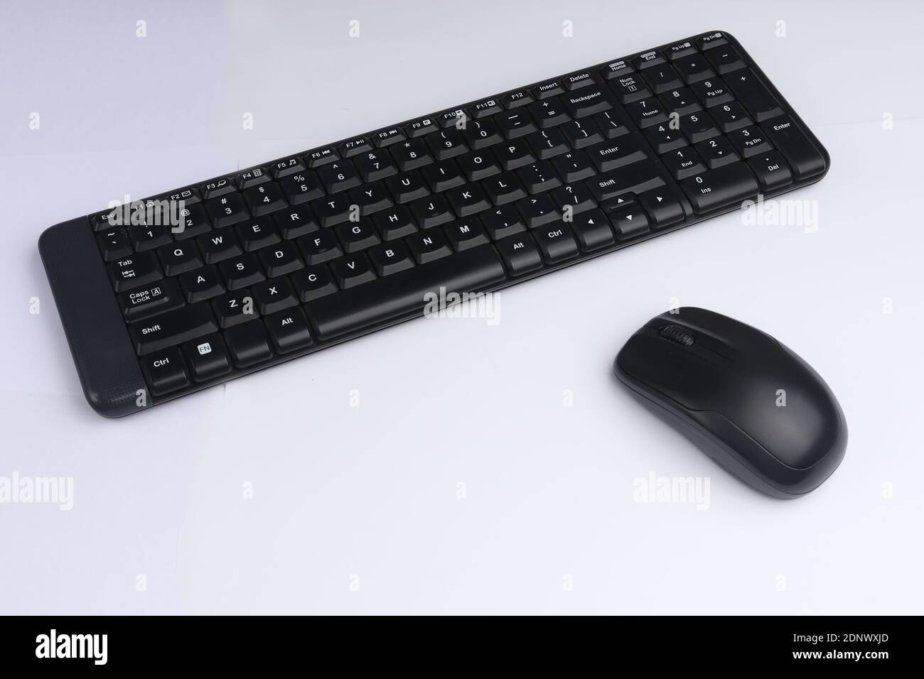 black mouse and keyboard with isolated white background. technology ...