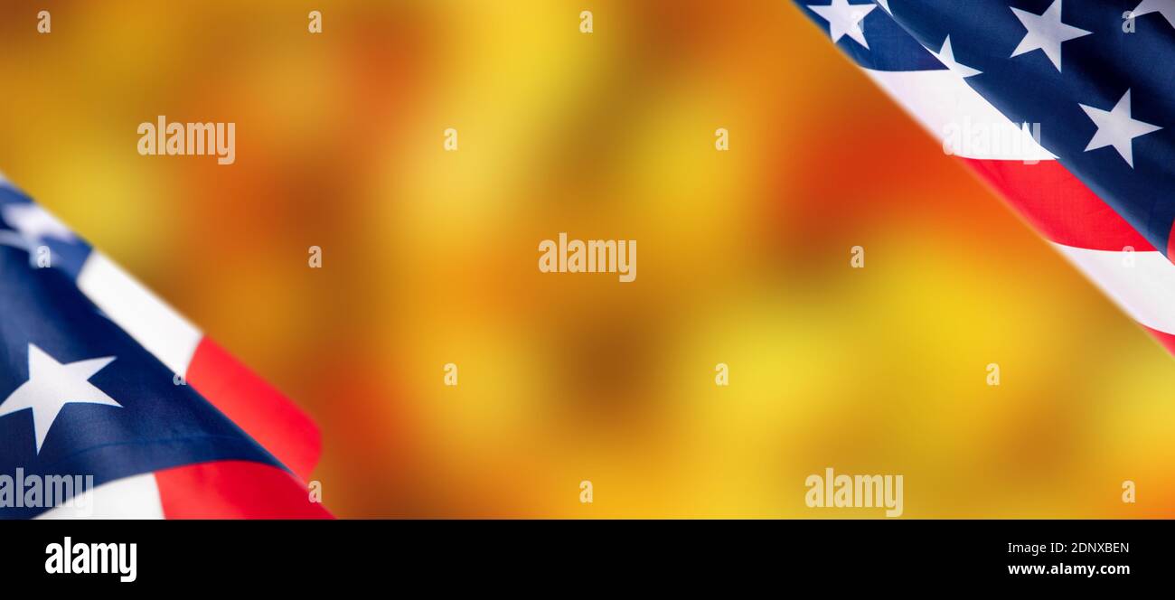American flags border over defocused yellow bokeh lights background ...