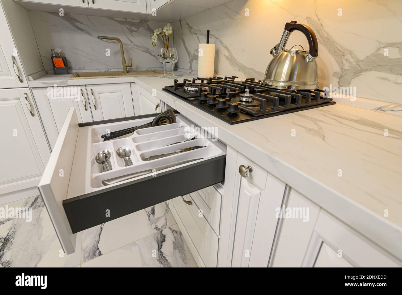 Open drawers with kitchenware at modern white kitchen Stock Photo - Alamy