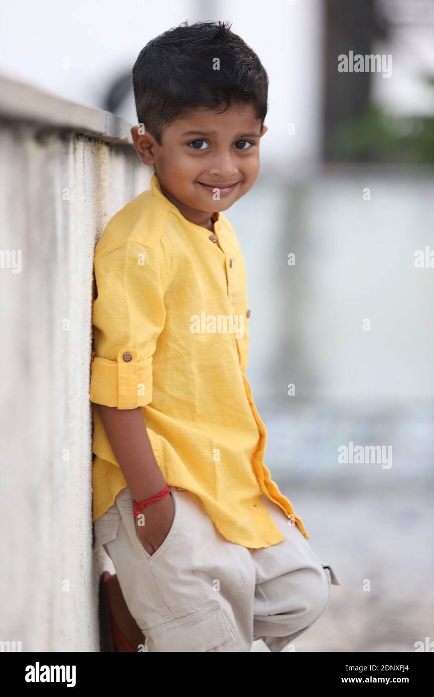 Side View Portrait Of Cute Smiling Boy With Hand In Pocket Standing ...