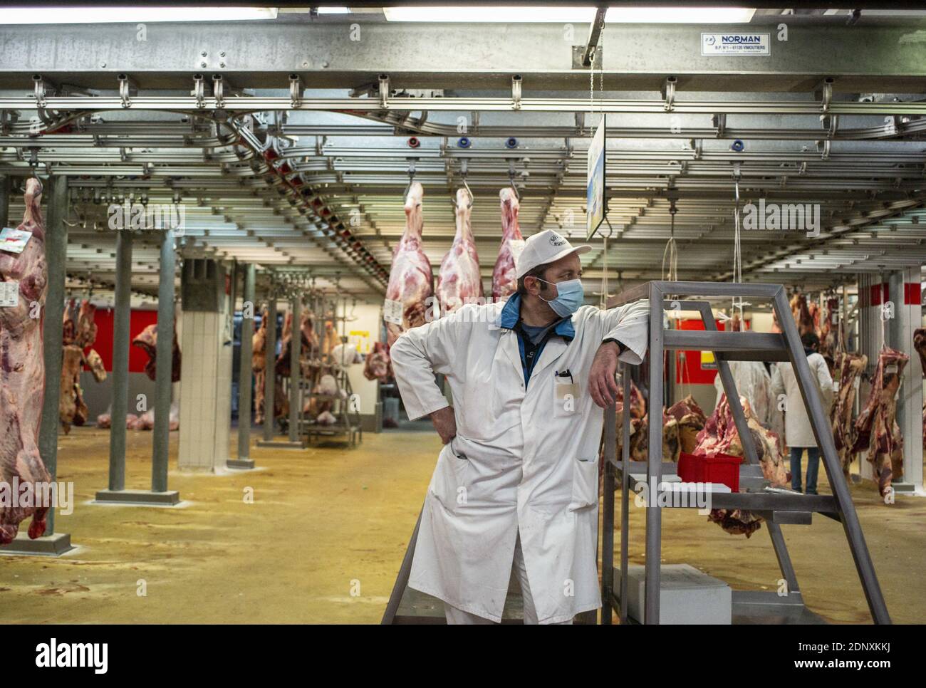 An employee works at the meat pavilion of the International Food Market ...