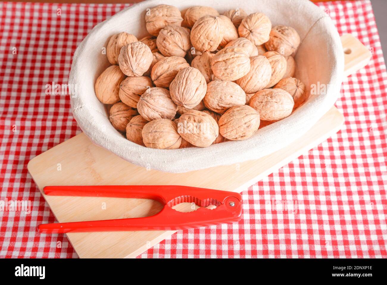 Mixed of nuts, hazelnuts and dried peanuts with nutcracker on wooden ...