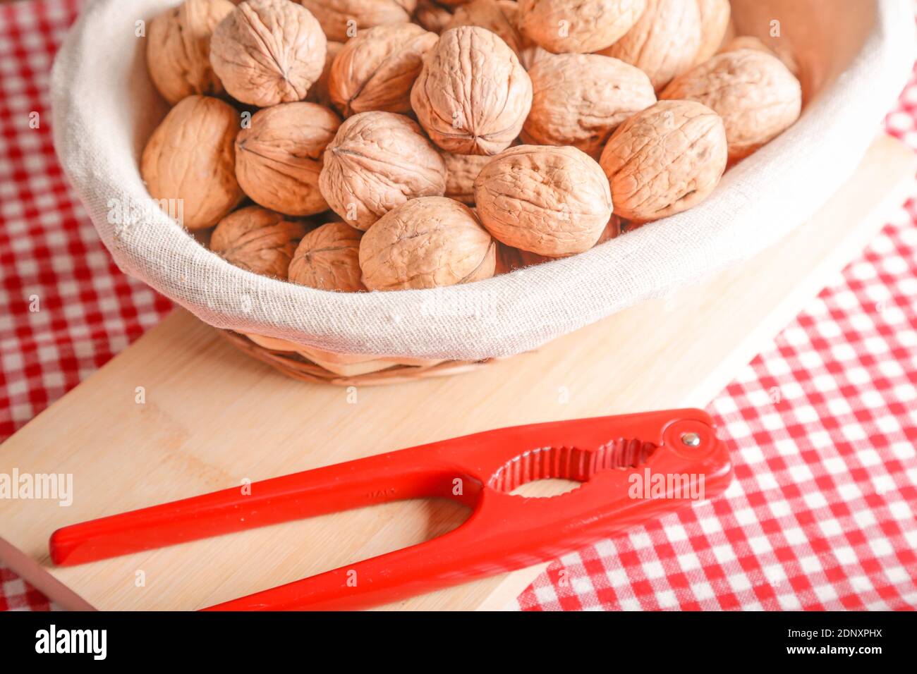 Mixed of nuts, hazelnuts and dried peanuts with nutcracker on wooden ...