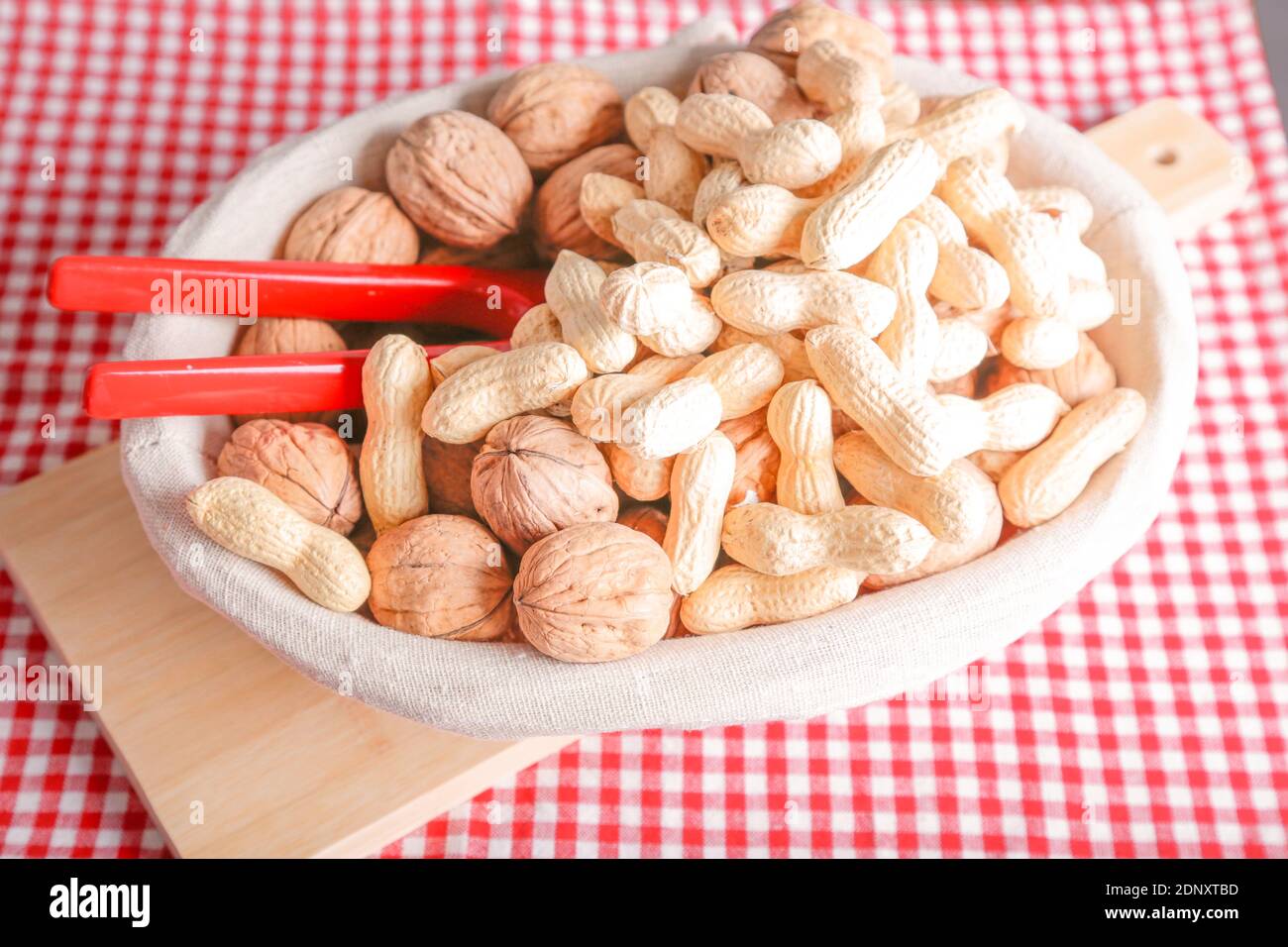 Mixed of nuts, hazelnuts and dried peanuts with nutcracker on wooden ...