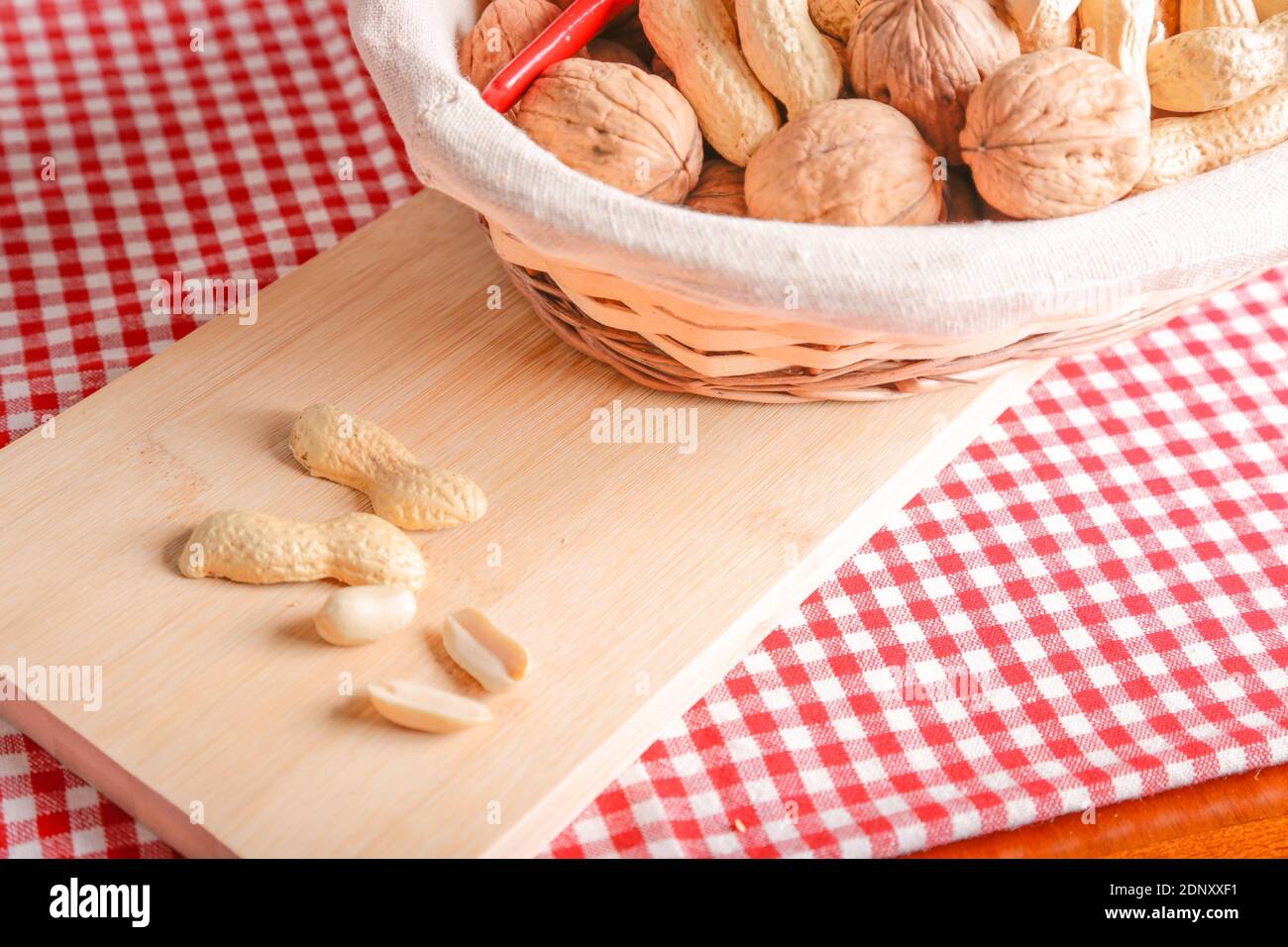 Mixed of nuts, hazelnuts and dried peanuts with nutcracker on wooden ...