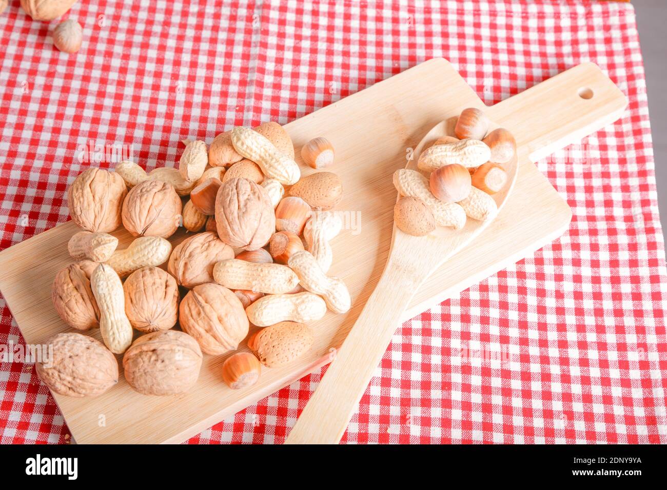 Mixed of nuts, hazelnuts and dried peanuts with nutcracker on wooden ...