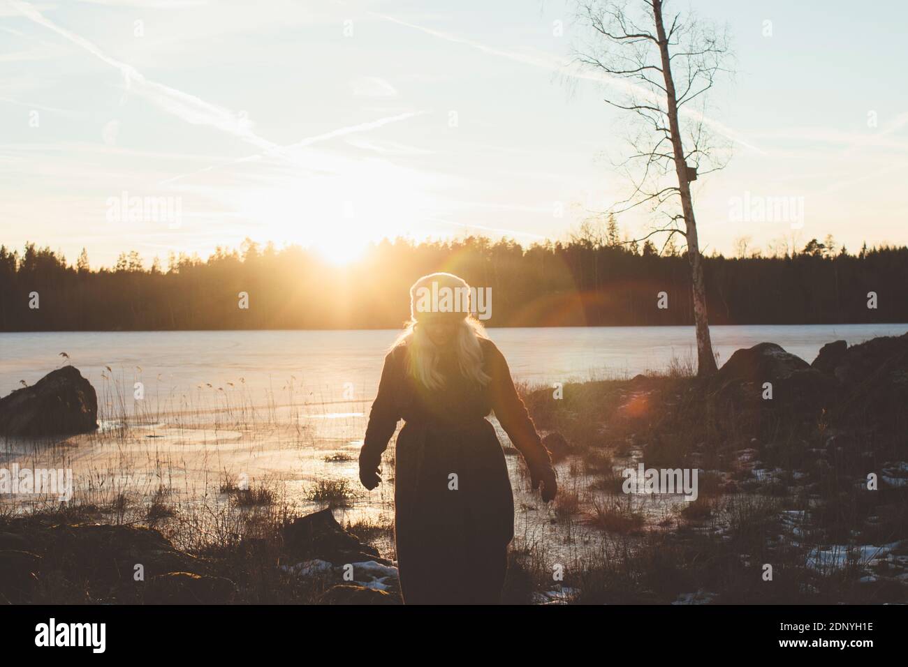 Woman walking at lake Stock Photo - Alamy