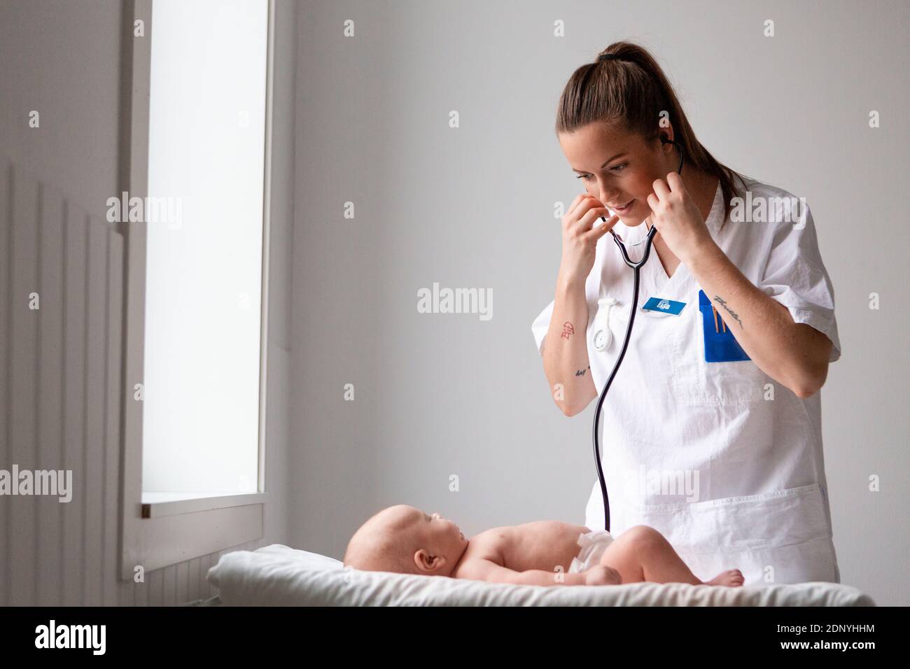 Female doctor examining baby Stock Photo - Alamy