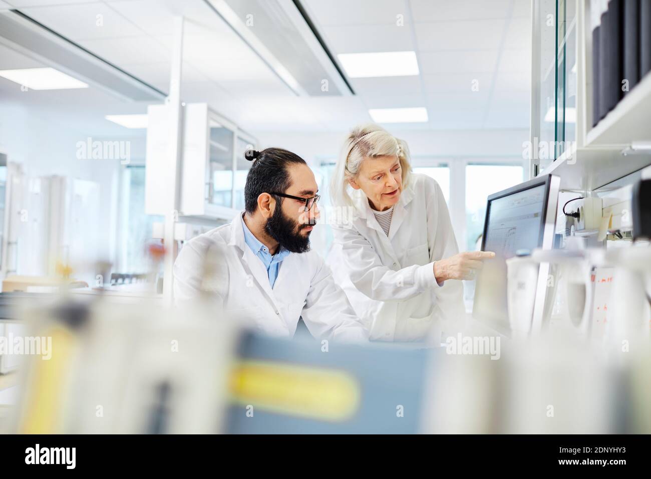 Coworkers talking in laboratory Stock Photo - Alamy