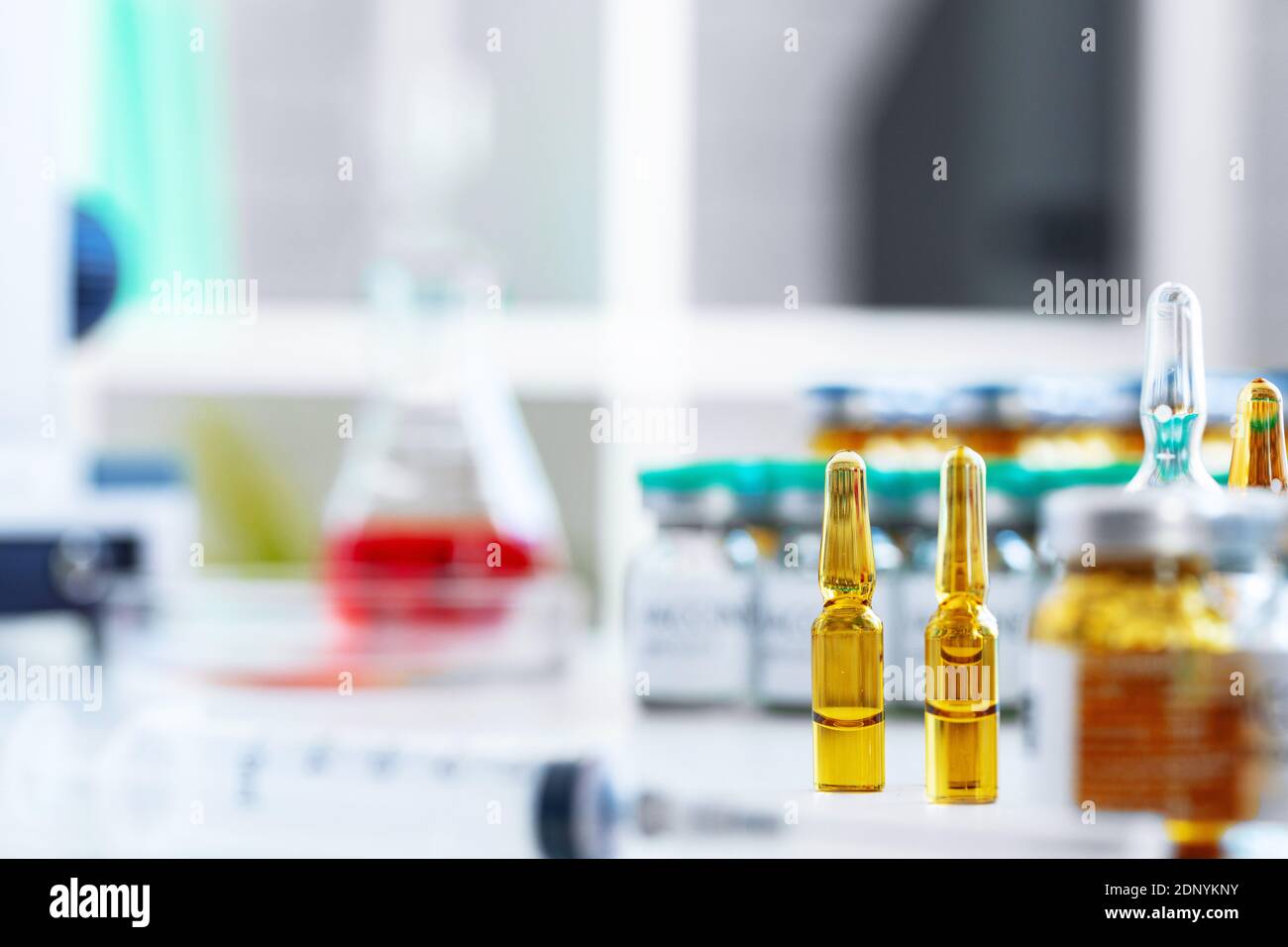 Glass bottle of medication for injections on table Stock Photo - Alamy