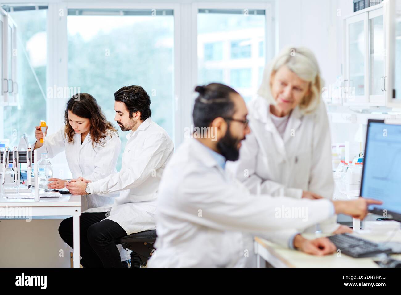 Coworkers talking in laboratory Stock Photo - Alamy
