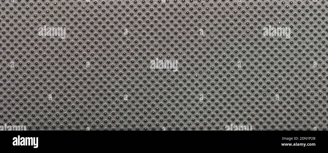 Dark metal surface with dots macro close up view. Pattern of grill on ...