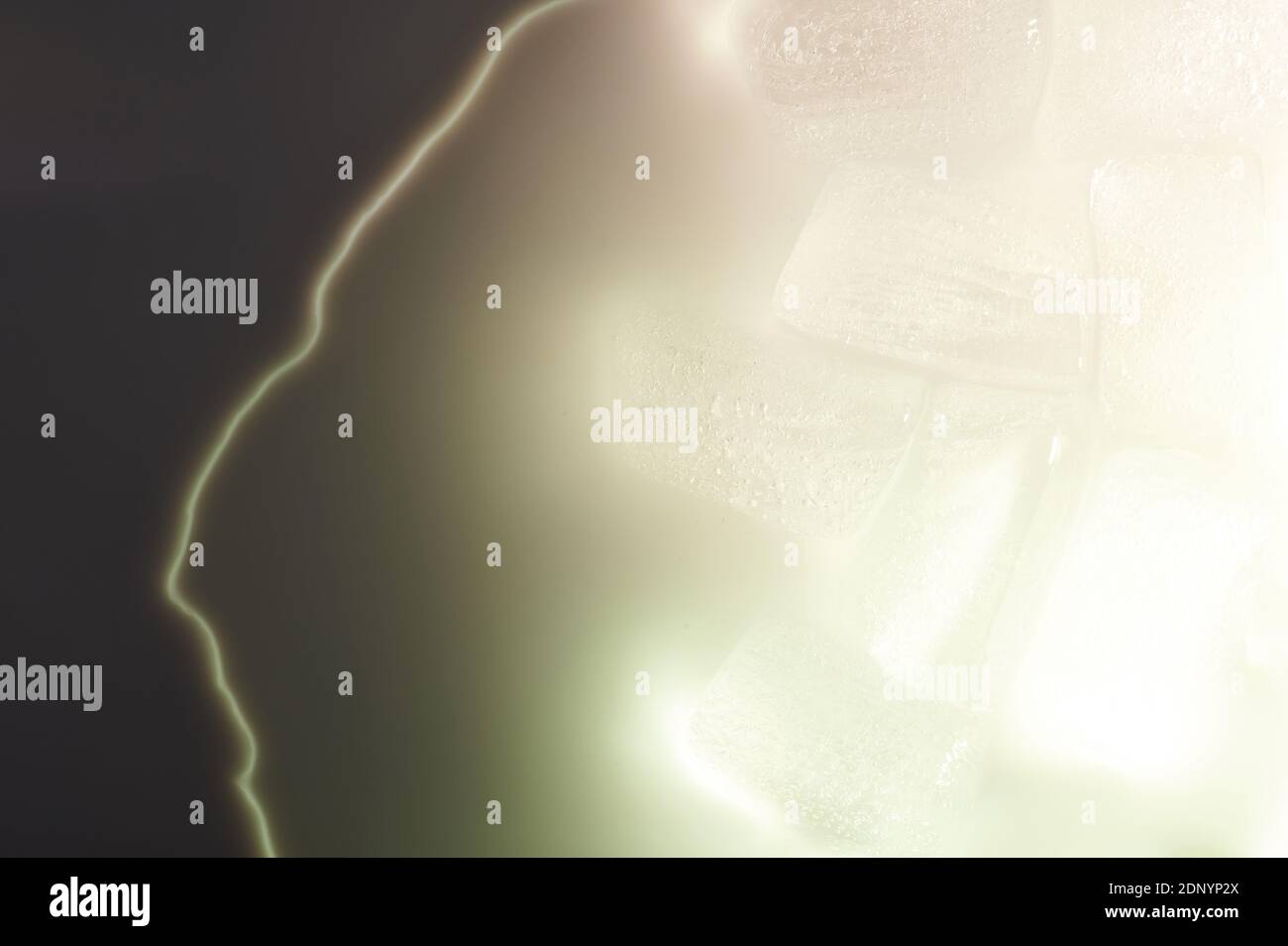 Pile of melting yellow glowing ice in water above view Stock Photo - Alamy