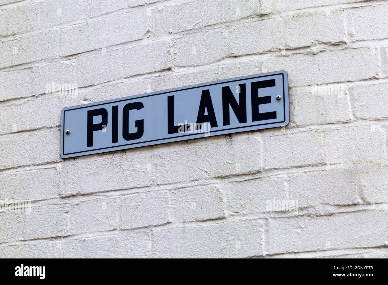 Pig Lane sign on side of building at Axminster, Devon UK in November ...