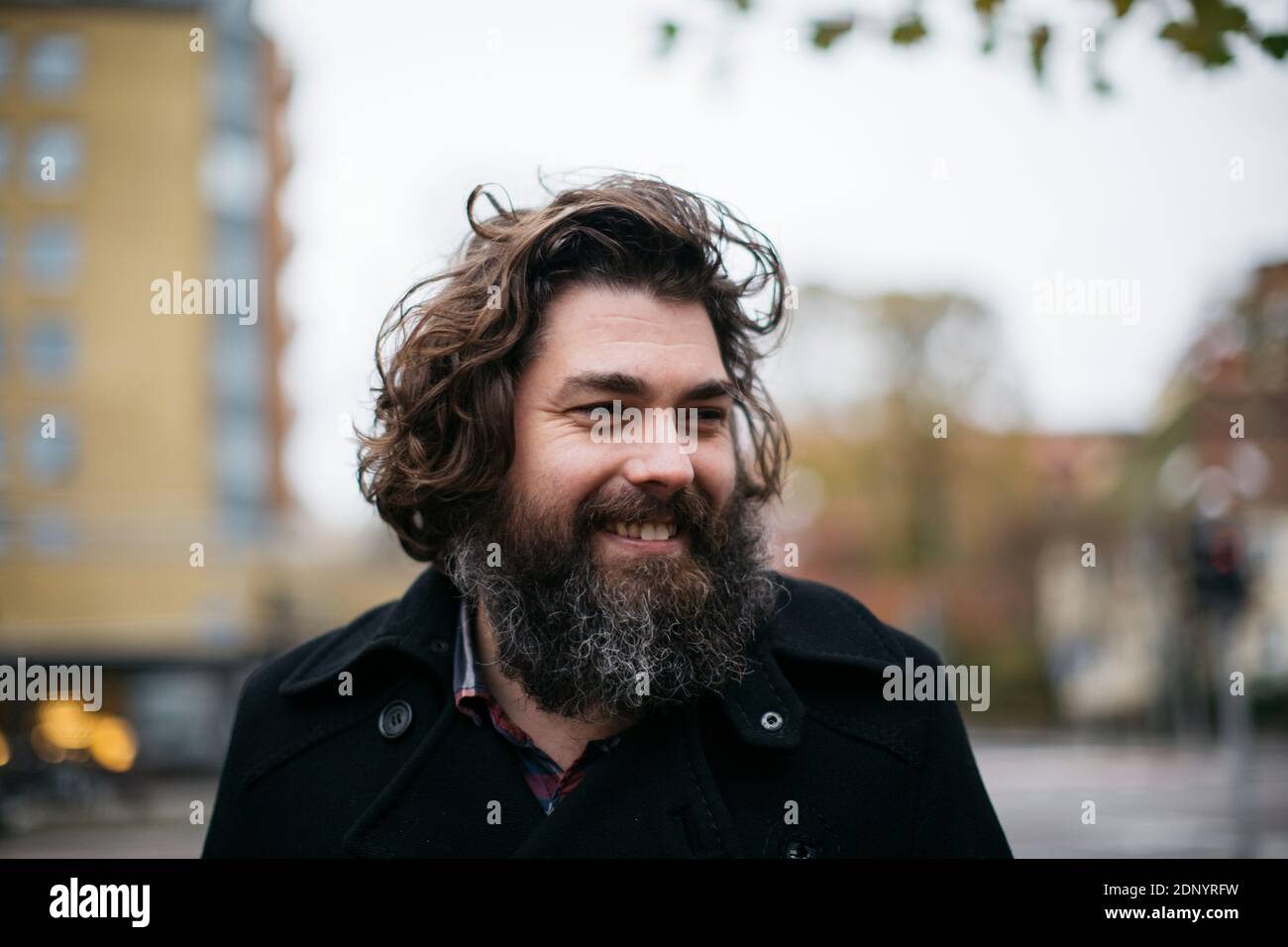Bearded man smiling outdoors Stock Photo - Alamy