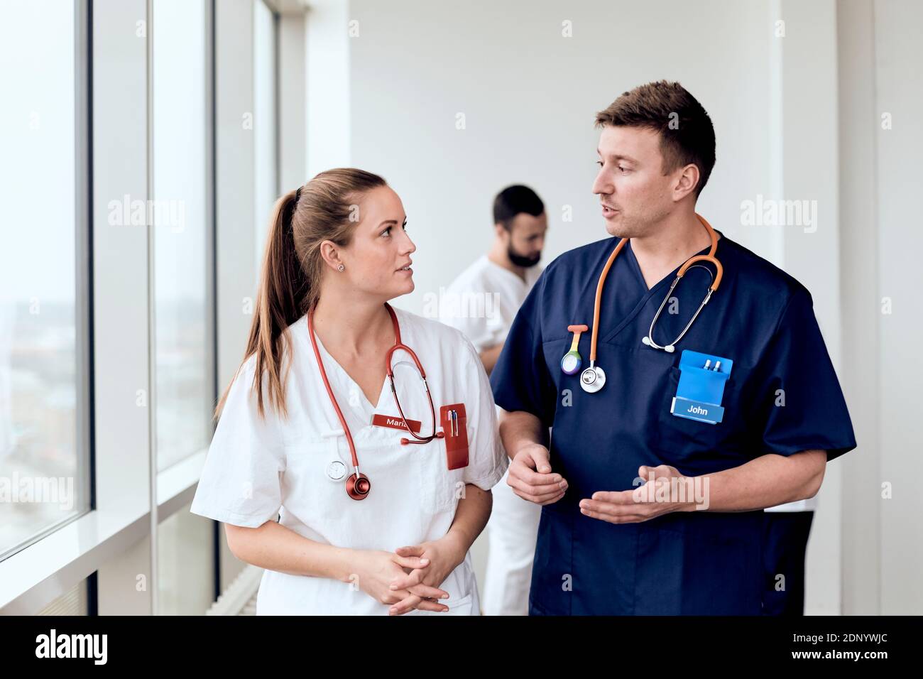 Doctors talking on corridor Stock Photo - Alamy