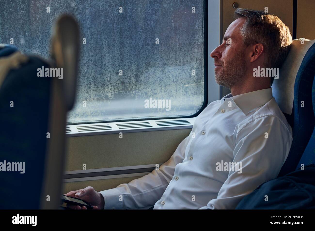 Man sleeping in train Stock Photo - Alamy