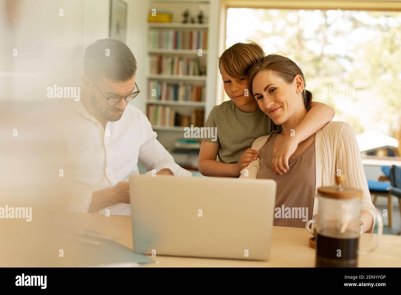 Boy with parents at home Stock Photo - Alamy