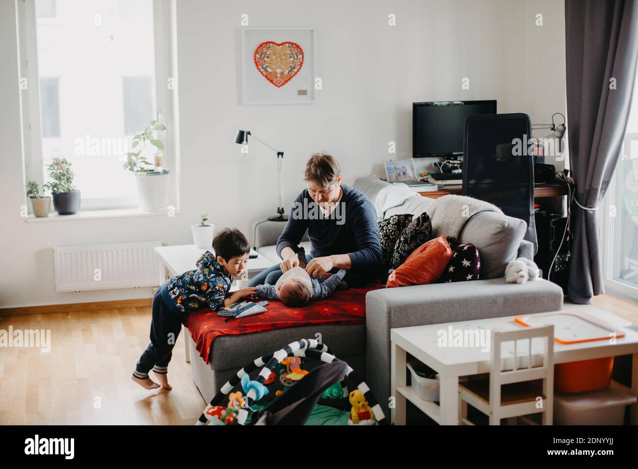 Father with children in living room Stock Photo - Alamy