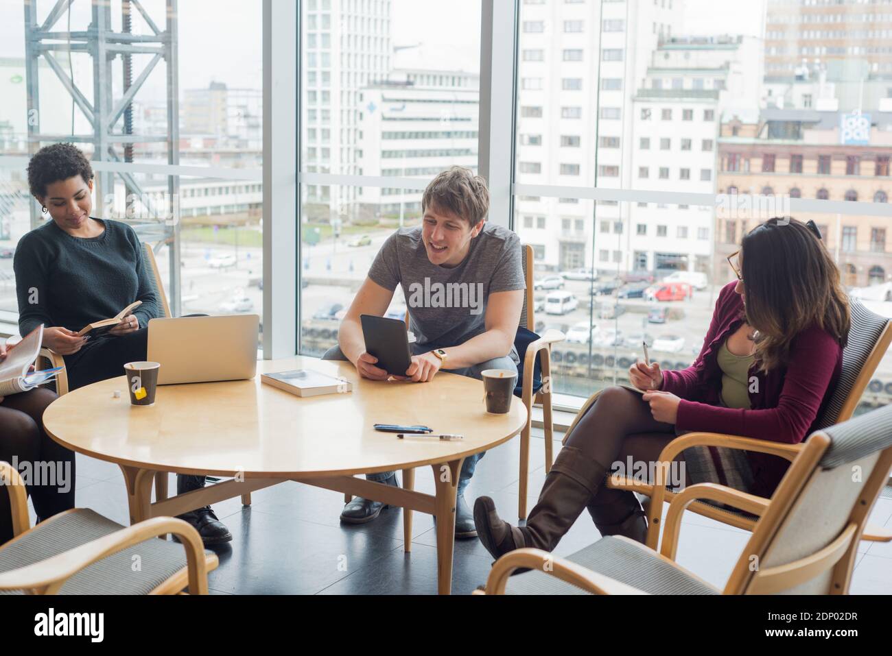 People sitting in library Stock Photo - Alamy