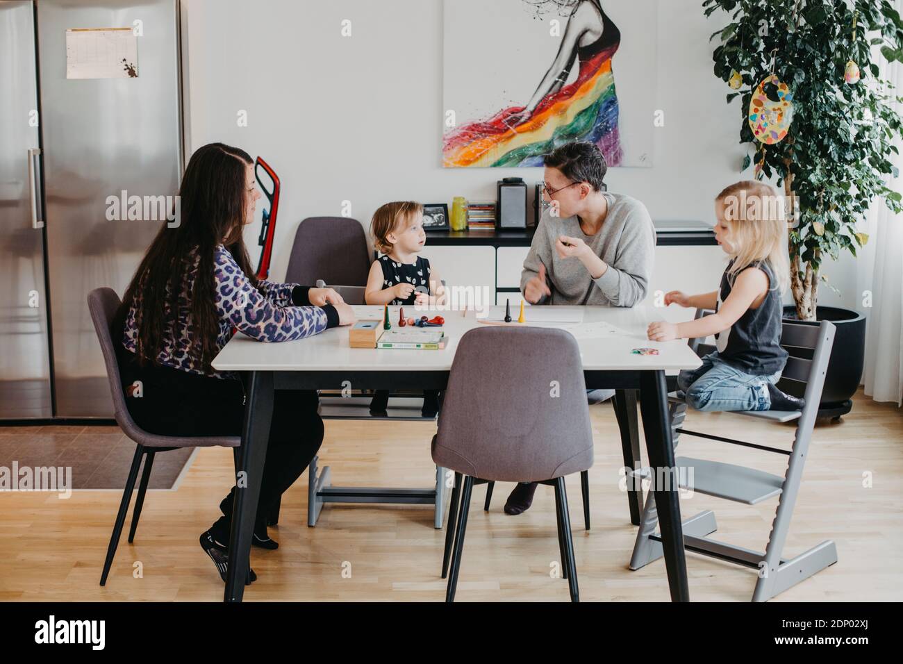 Parents daughter sitting table hi-res stock photography and images - Alamy
