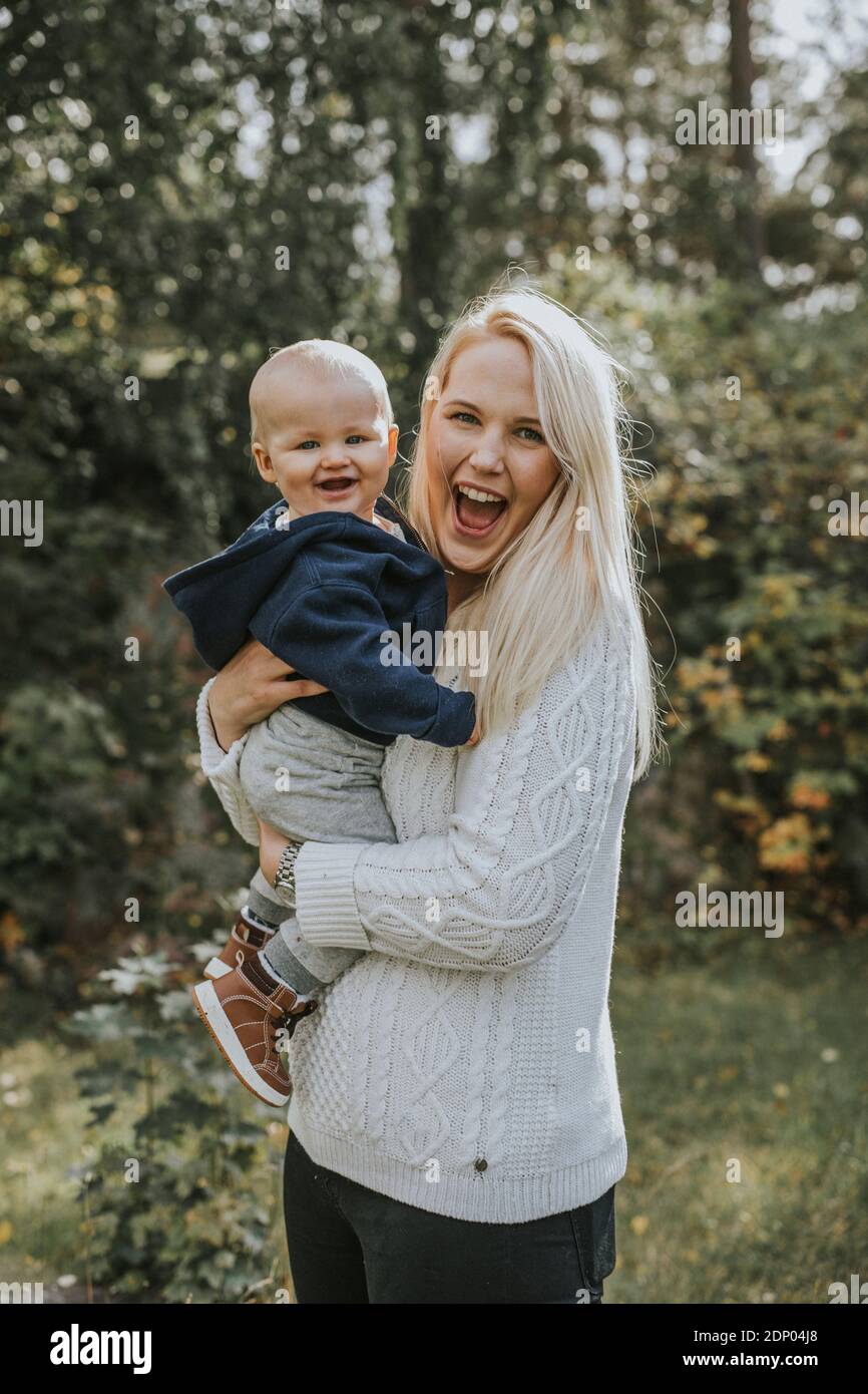 Mother carrying baby Stock Photo - Alamy