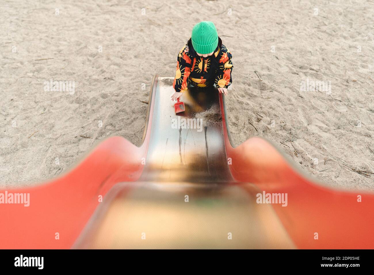 Girl standing on bottom of metal slide Stock Photo - Alamy