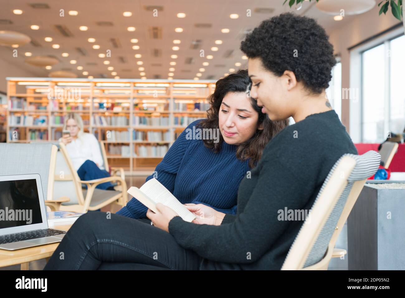 Women sitting in library Stock Photo - Alamy