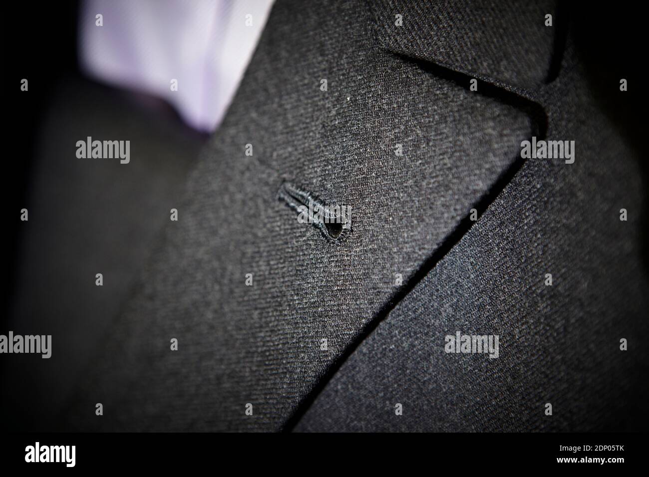 Dark grey formal suit lapel with button hole. Close up Stock Photo - Alamy