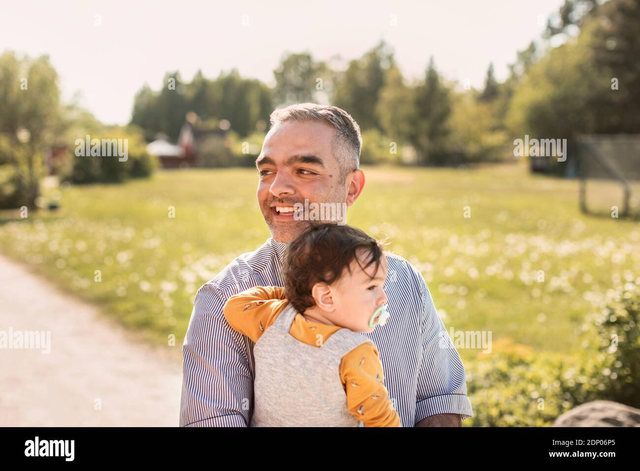 Man carrying baby hi-res stock photography and images - Alamy