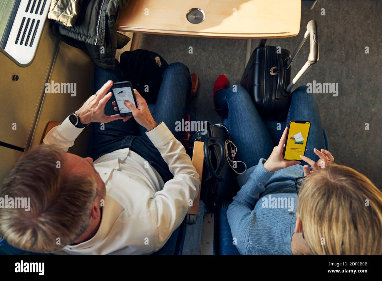 Man and woman in train using cell phones Stock Photo - Alamy