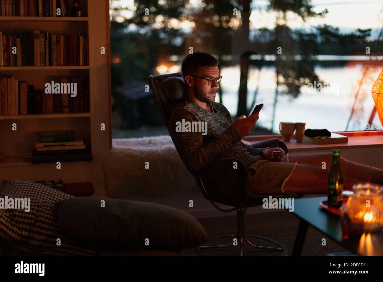 Man home using cell hi-res stock photography and images - Alamy