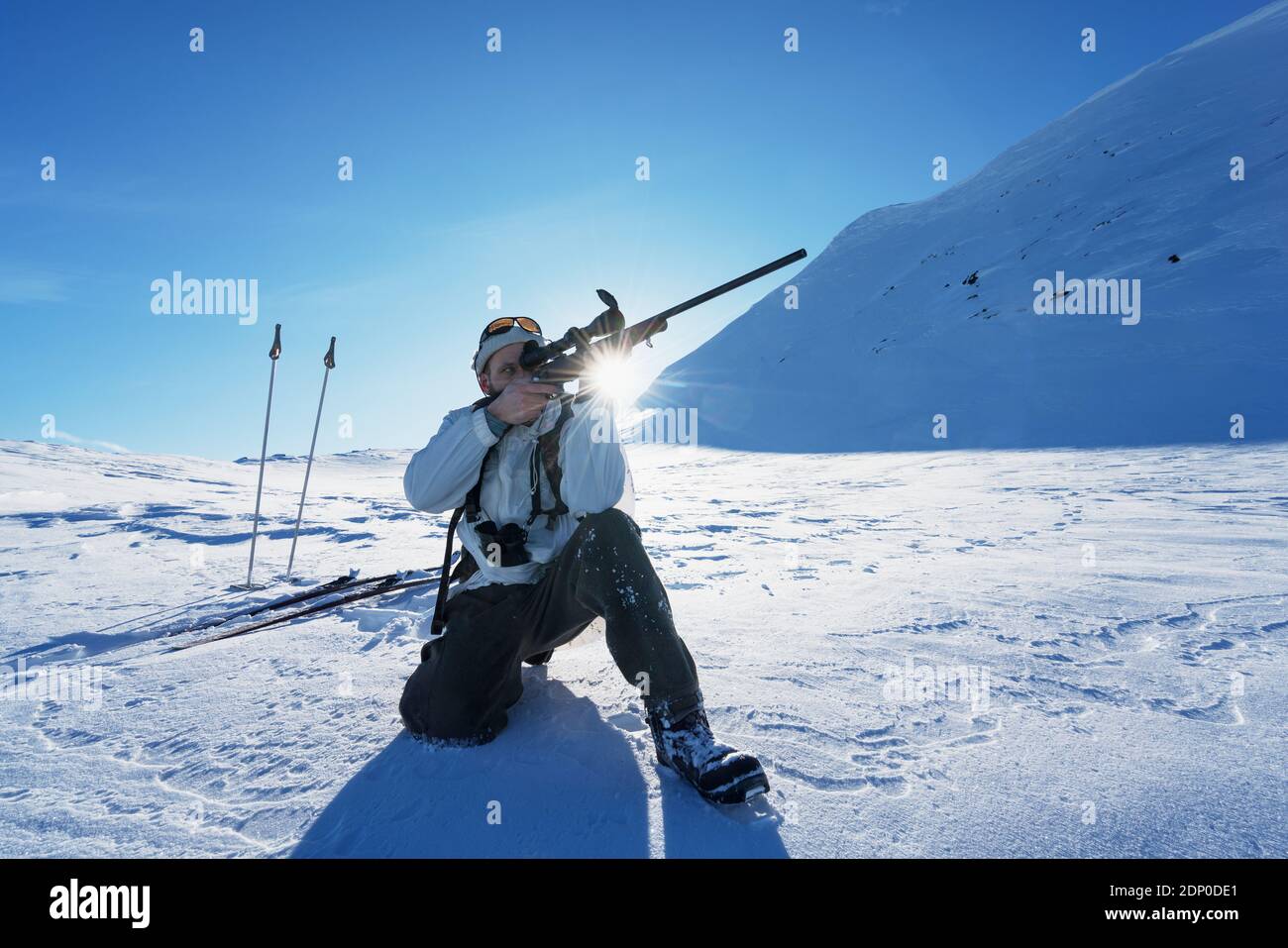 Cross country skier aiming rifle Stock Photo - Alamy