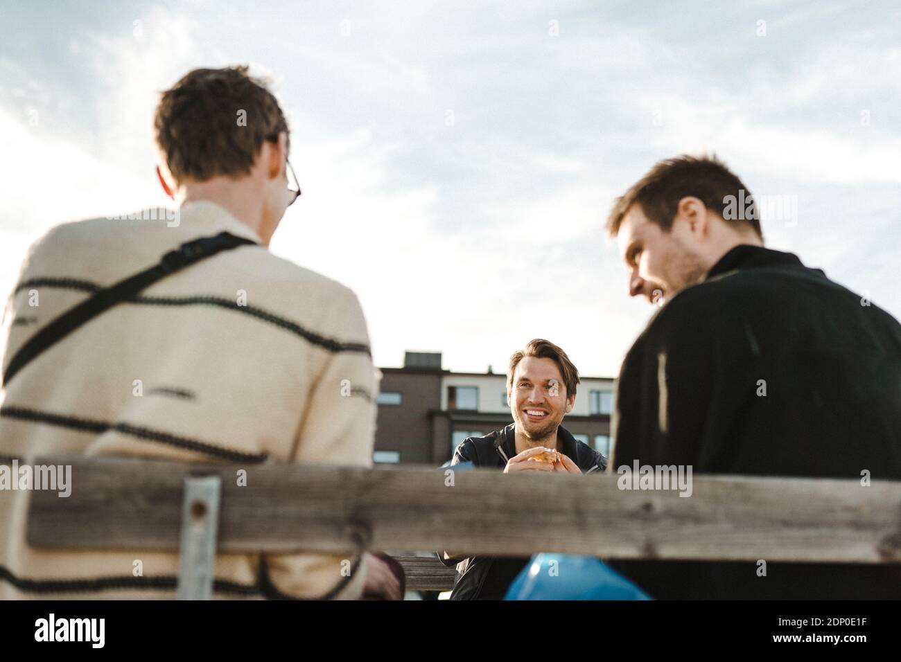 Smiling friends eating outdoor hi-res stock photography and images - Alamy