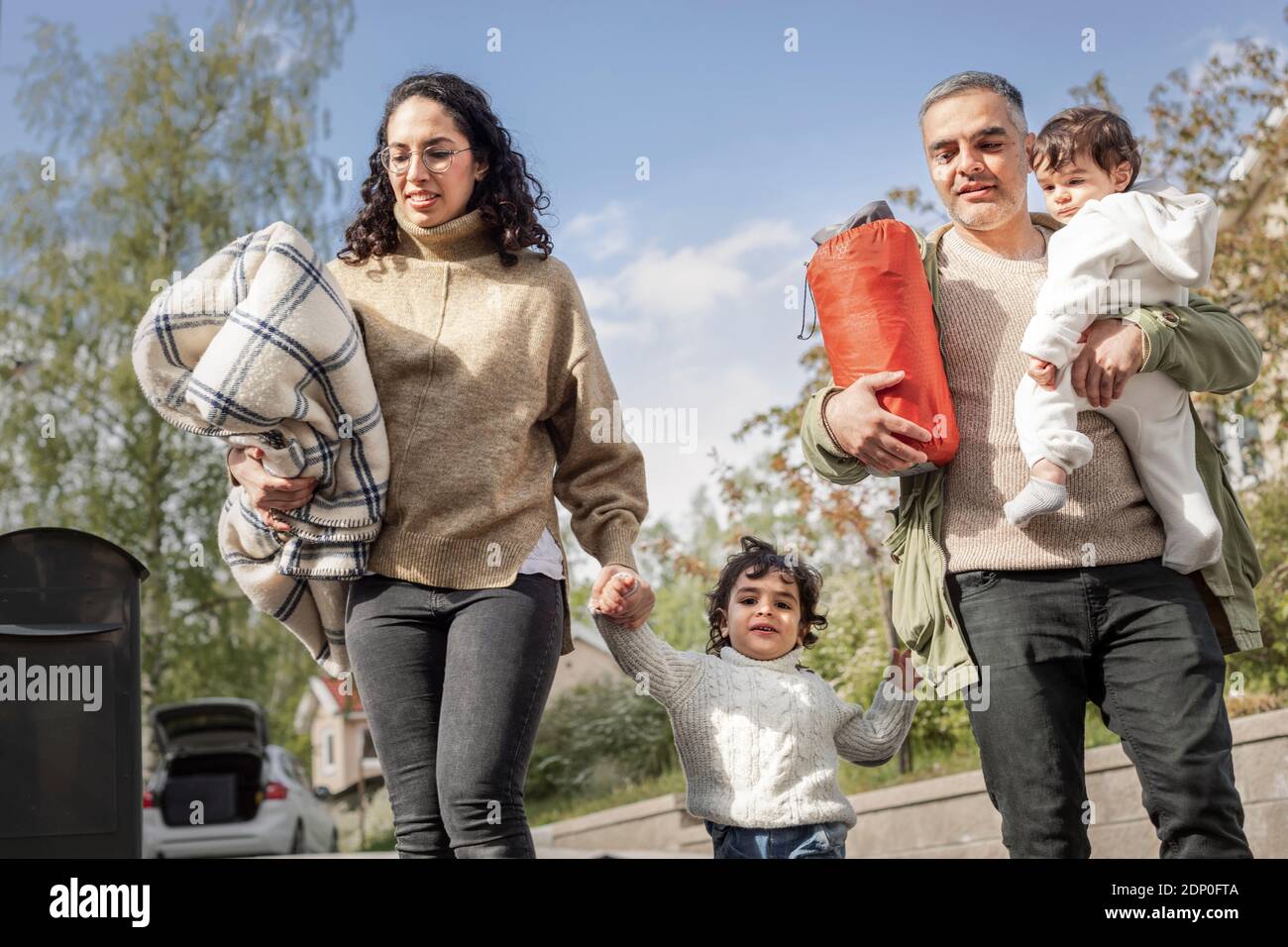 Parents walking with children Stock Photo - Alamy