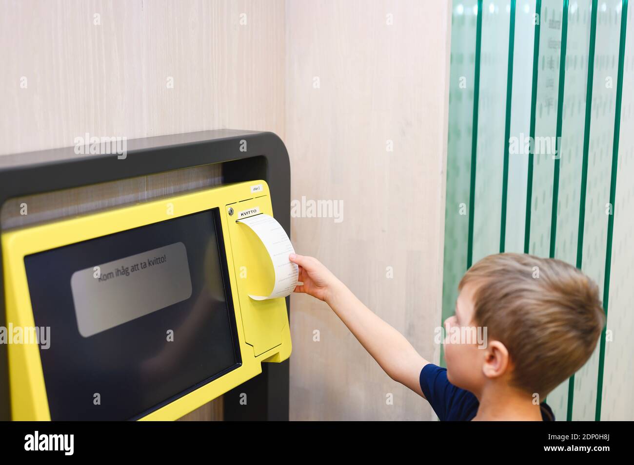Boy using self service point in library Stock Photo - Alamy