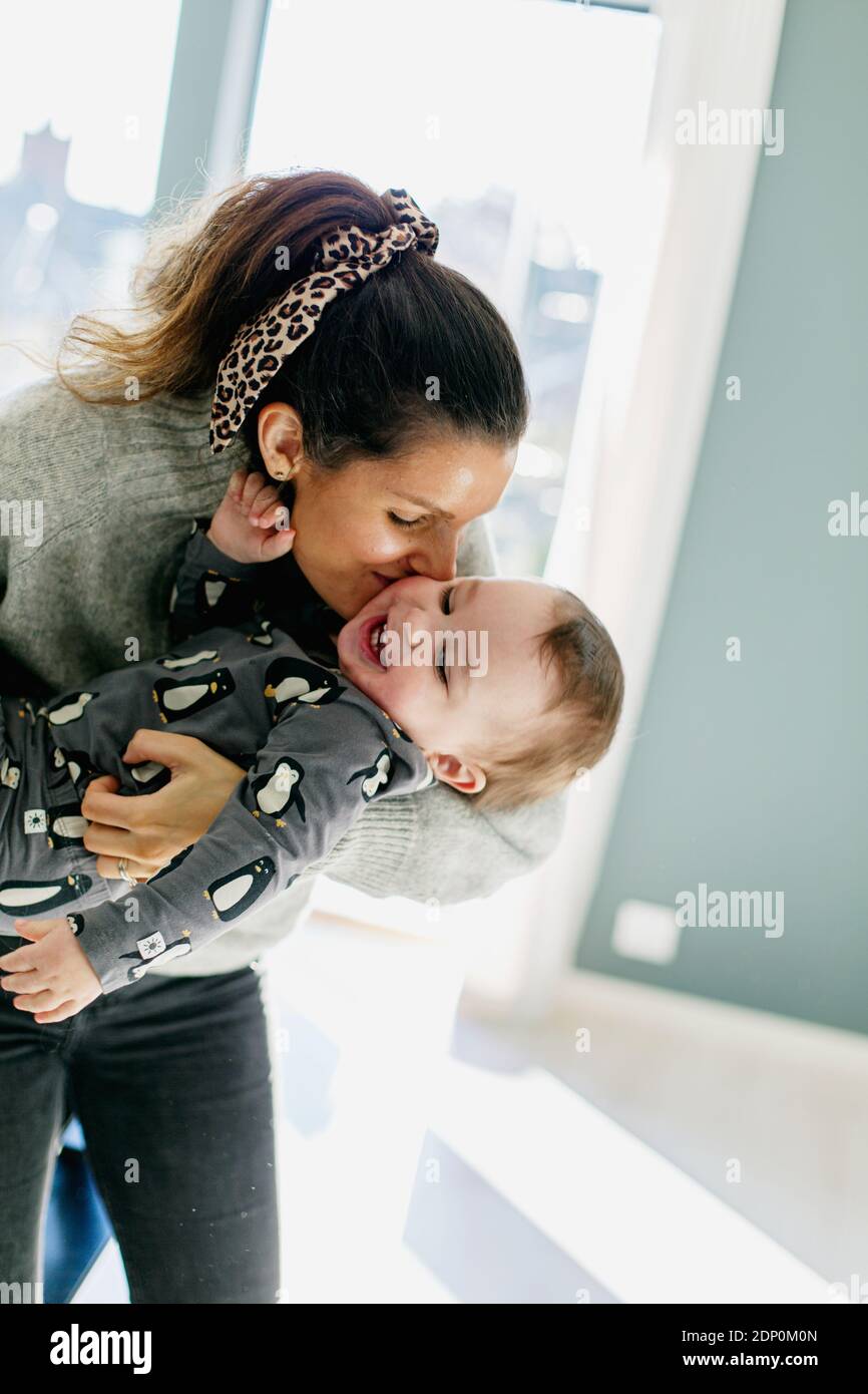 Mother carry toddler son sitting at table Stock Photo - Alamy